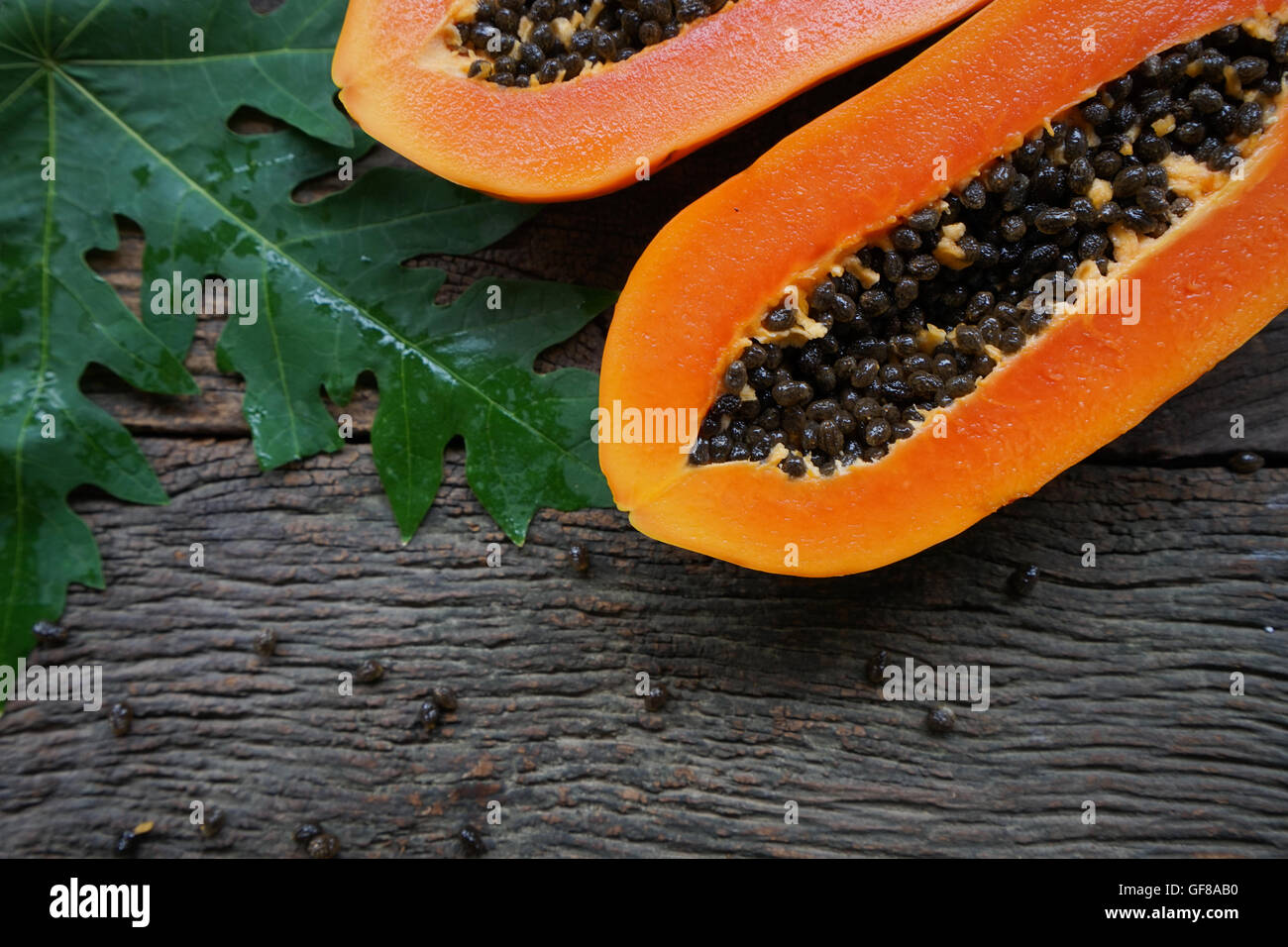 Top view Ripe papaya with green leaf on old wooden background Stock ...