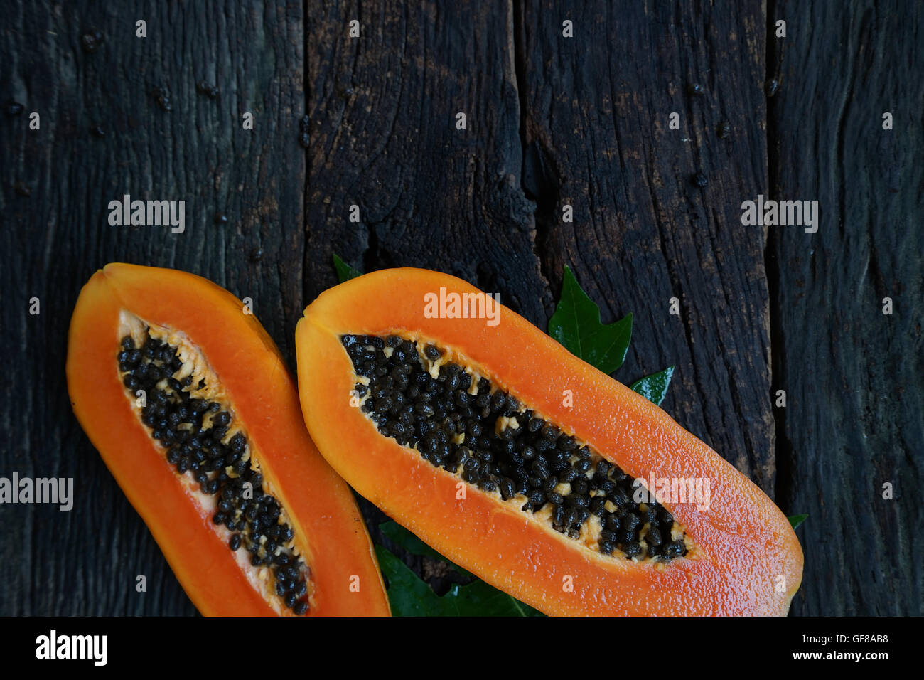 Top view Ripe papaya with green leaf on old wooden background Stock ...