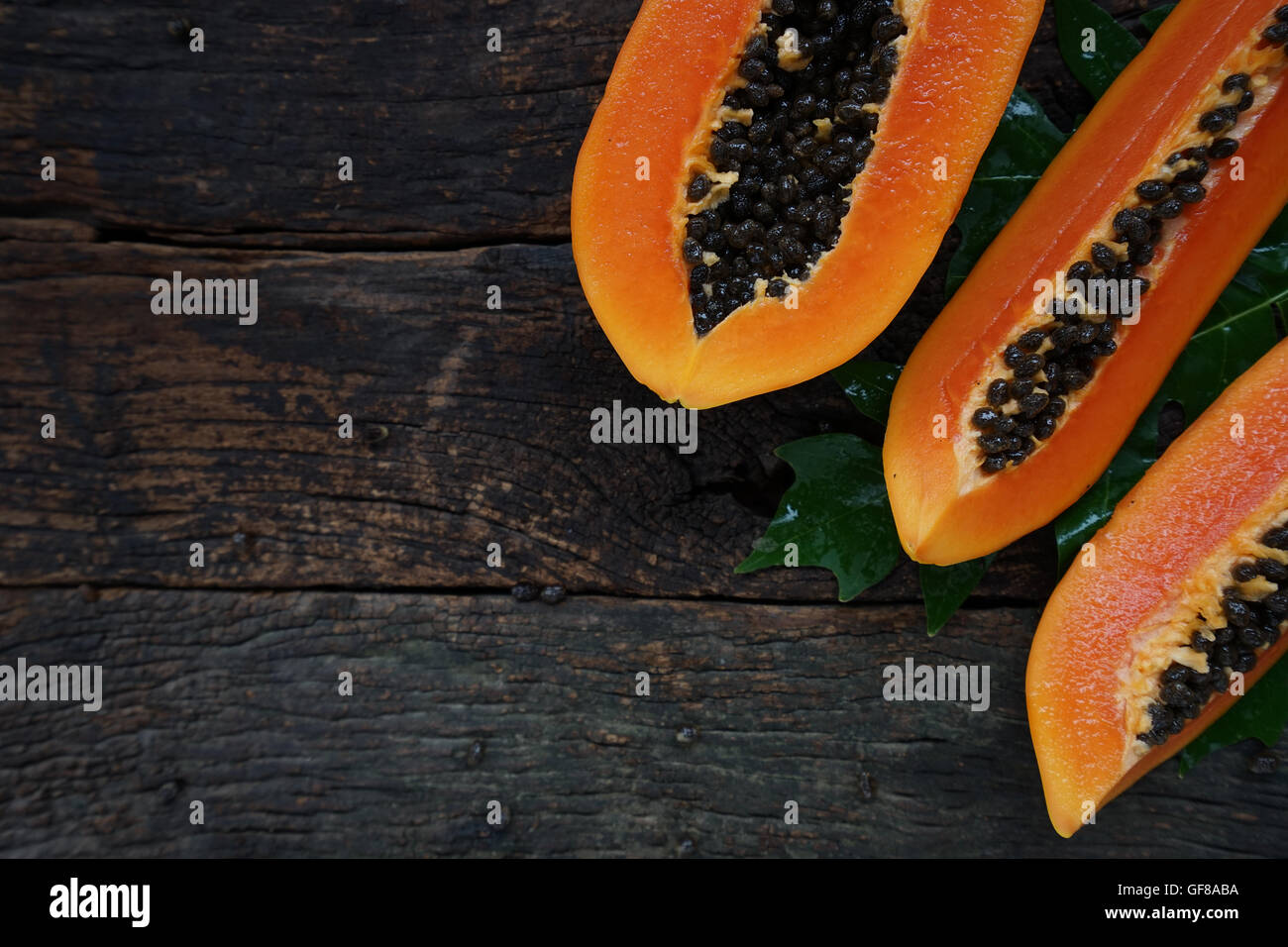 Top view Ripe papaya with green leaf on old wooden background Stock ...