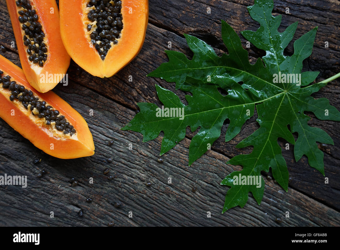 Top view Ripe papaya with green leaf on old wooden background Stock ...
