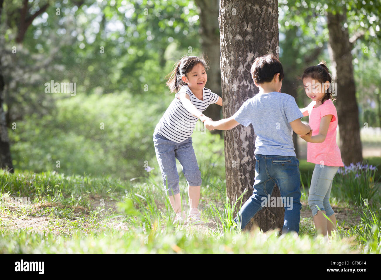 Happy Chinese children playing in woods Stock Photo - Alamy