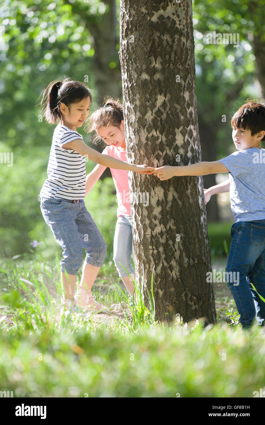 Happy Chinese children playing in woods Stock Photo - Alamy