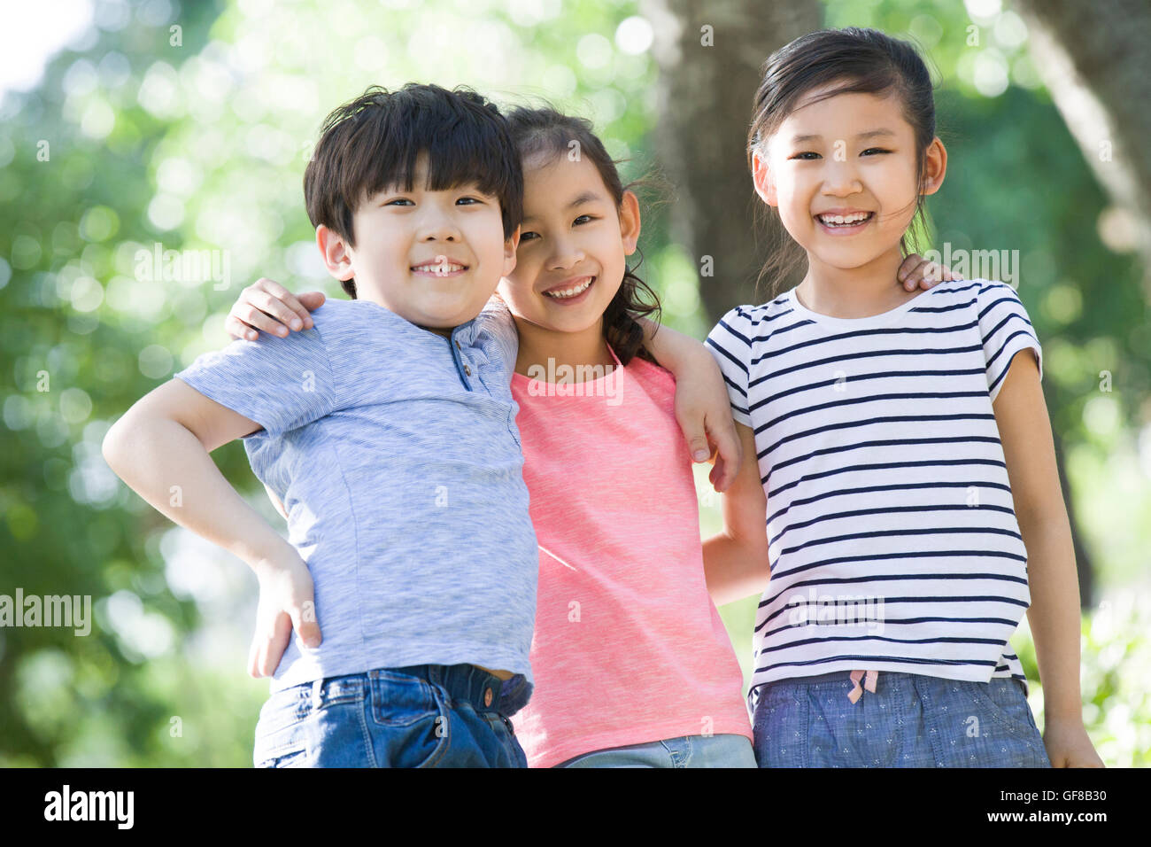 Portrait of happy Chinese children in woods Stock Photo - Alamy