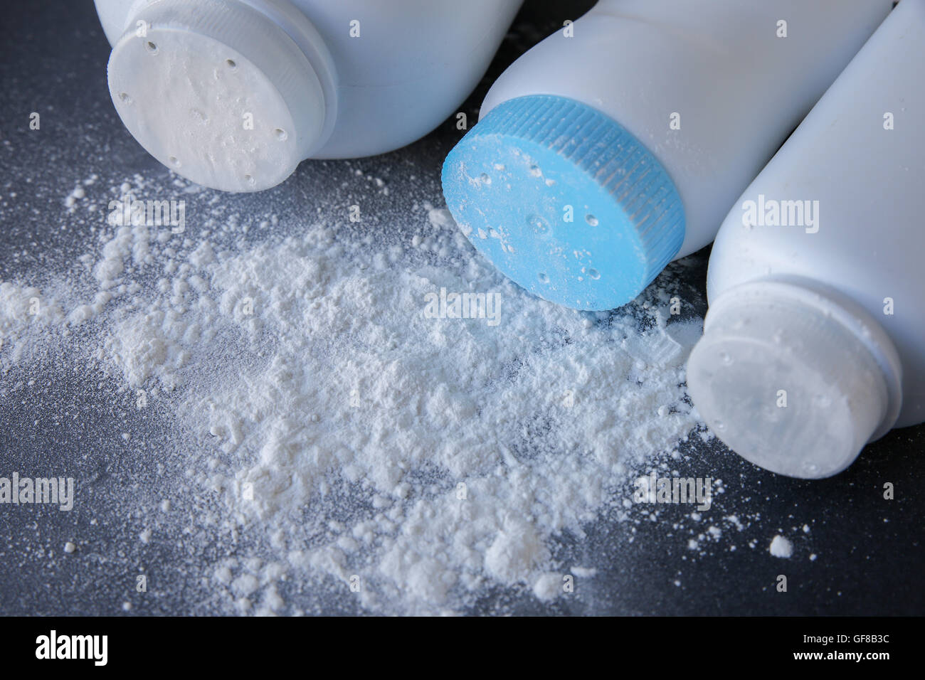 Talcum powder on black background Stock Photo - Alamy