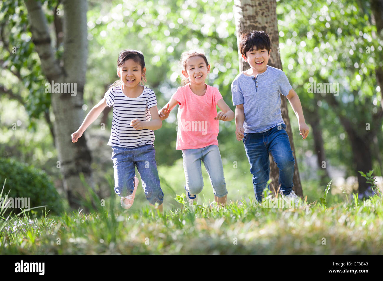Happy indian child running in the grass hi-res stock photography and ...