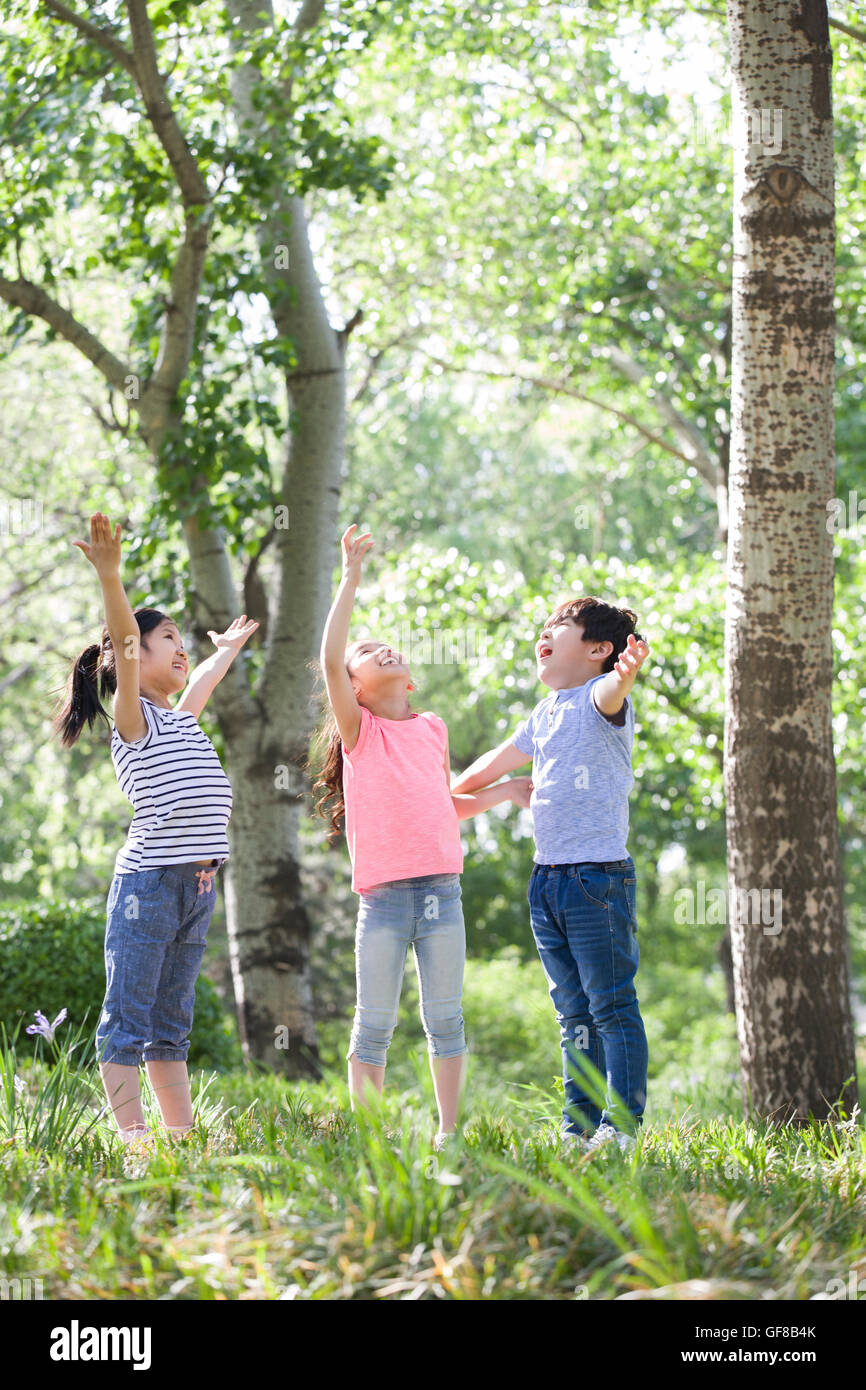 Happy Chinese children playing in woods Stock Photo - Alamy