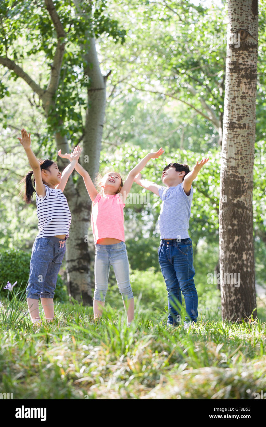 Happy Chinese children playing in woods Stock Photo - Alamy