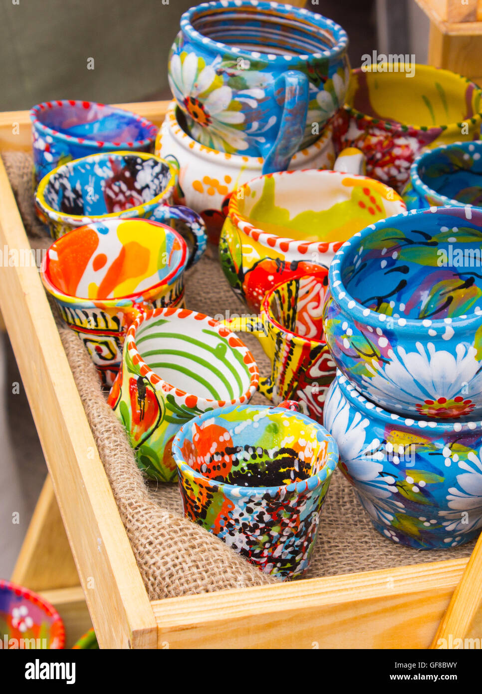 Collection of colorful cups and bowls for sale on stall at the bazaar ...