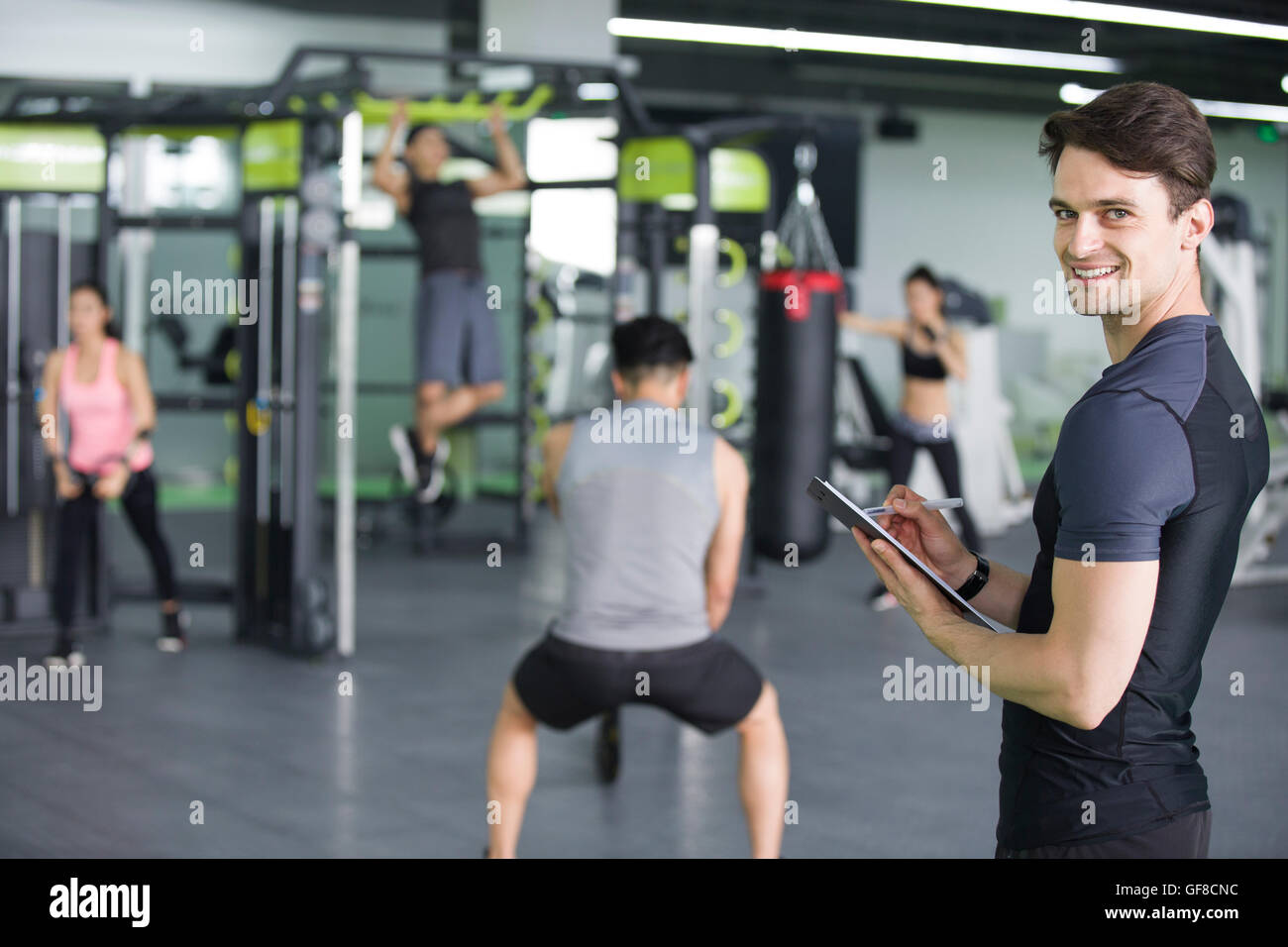 Portrait of fitness instructor at gym Stock Photo - Alamy