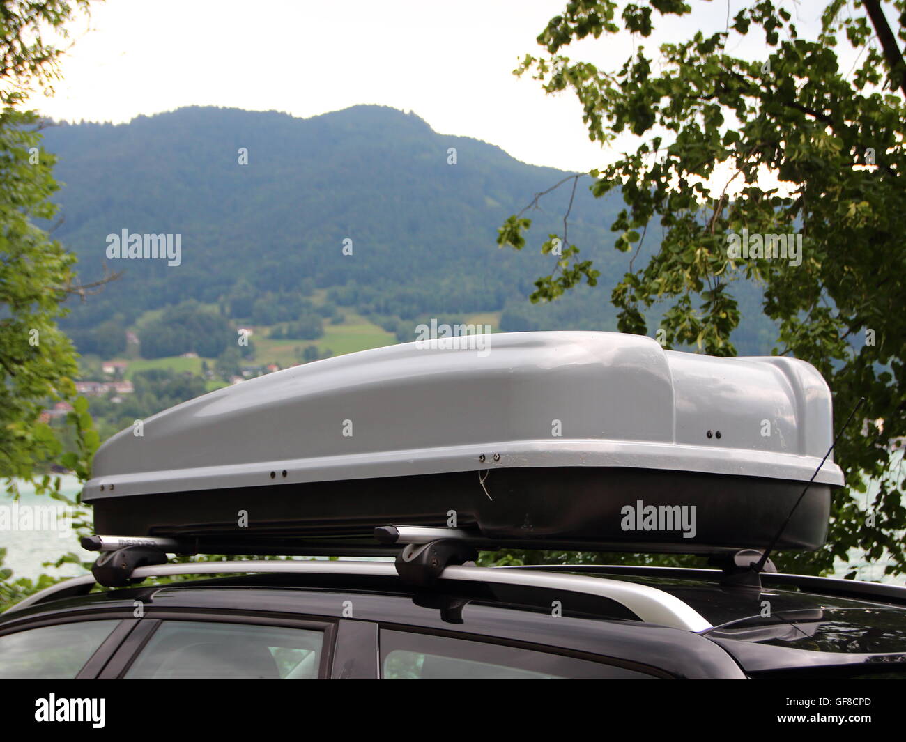 Car Rooftop Rack Box with Cloudy Mountain and Lake in Background ...