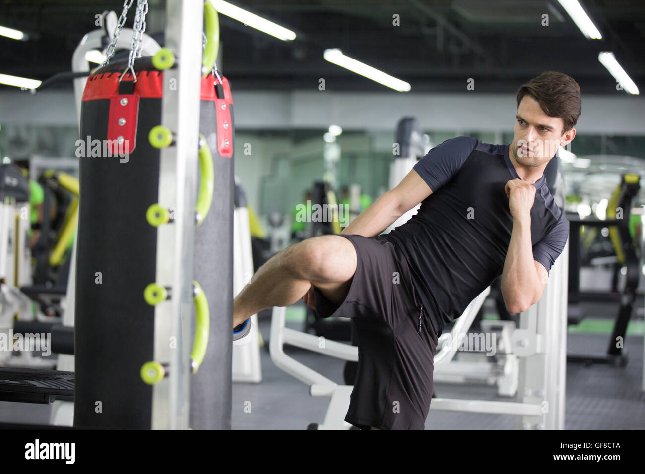 Young man exercising at gym Stock Photo - Alamy