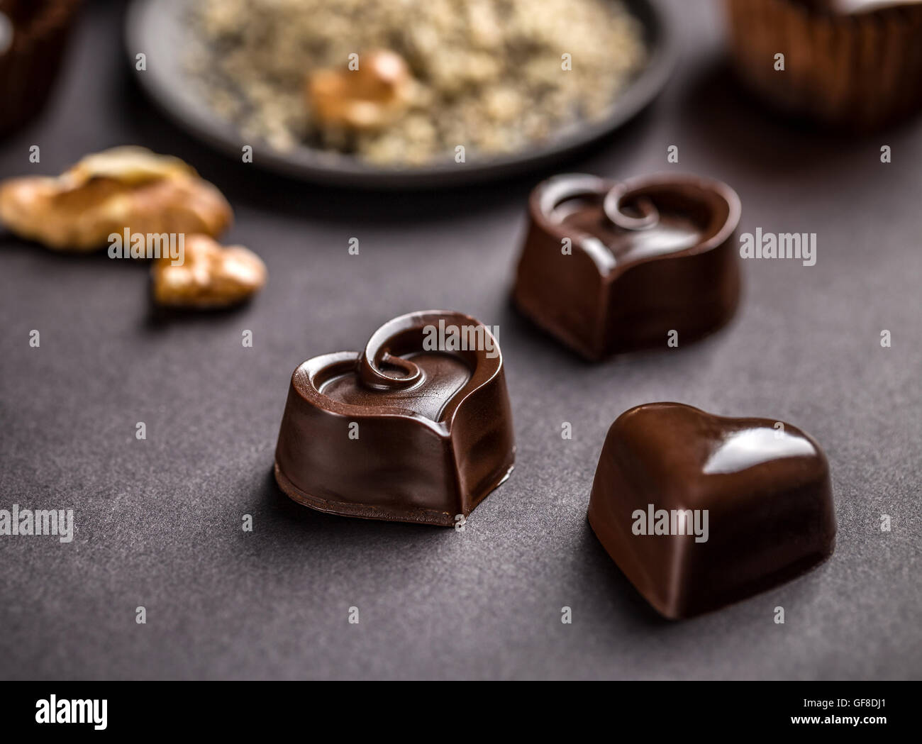 Dark heart shaped chocolate on black background Stock Photo - Alamy