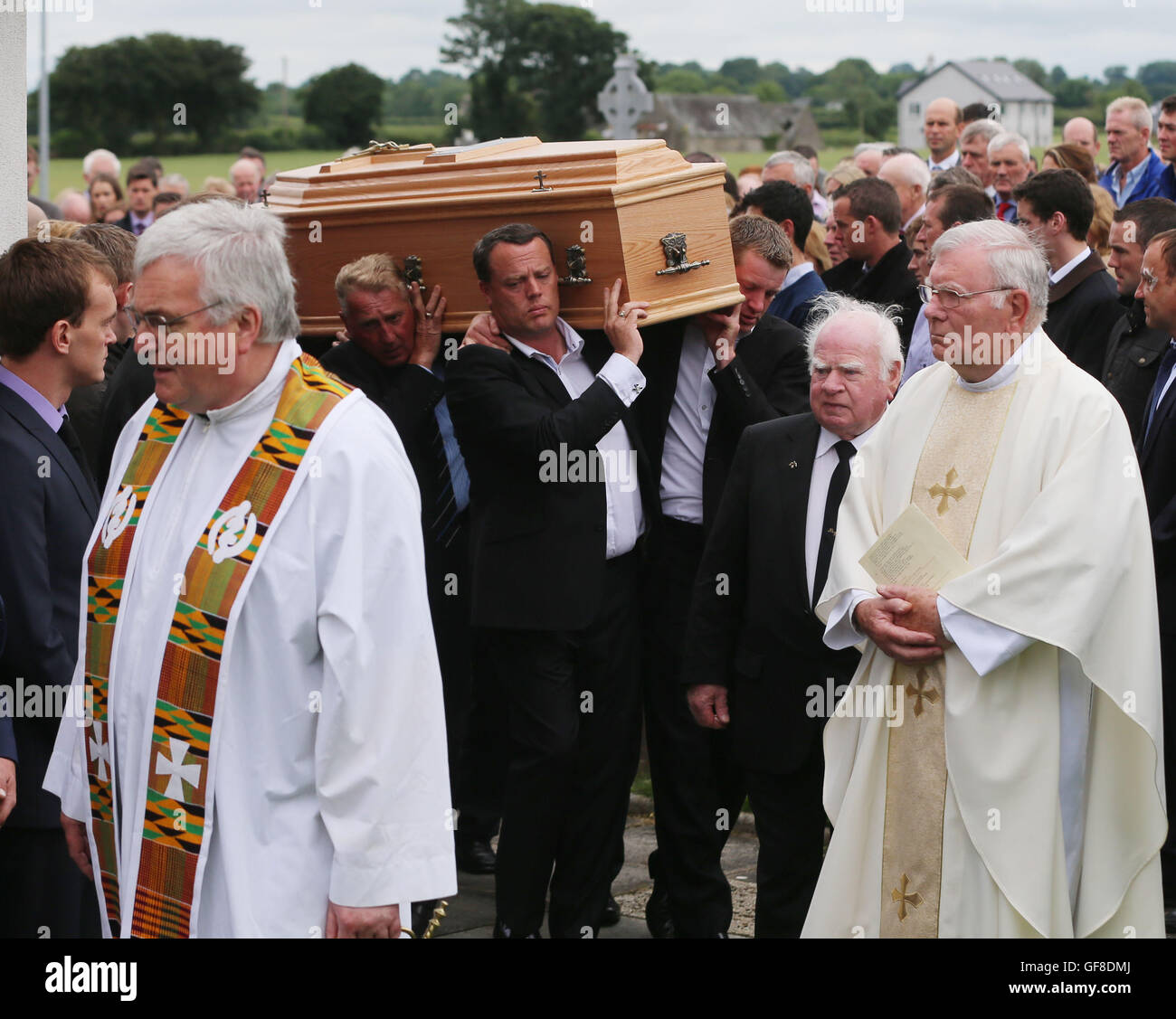 The coffins arrives at the funeral of amateur jockey John Thomas ...