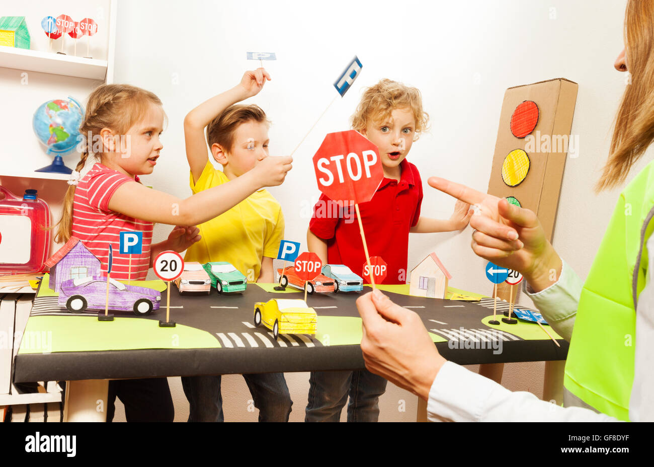 Cute kids having fun teaching traffic signs Stock Photo - Alamy
