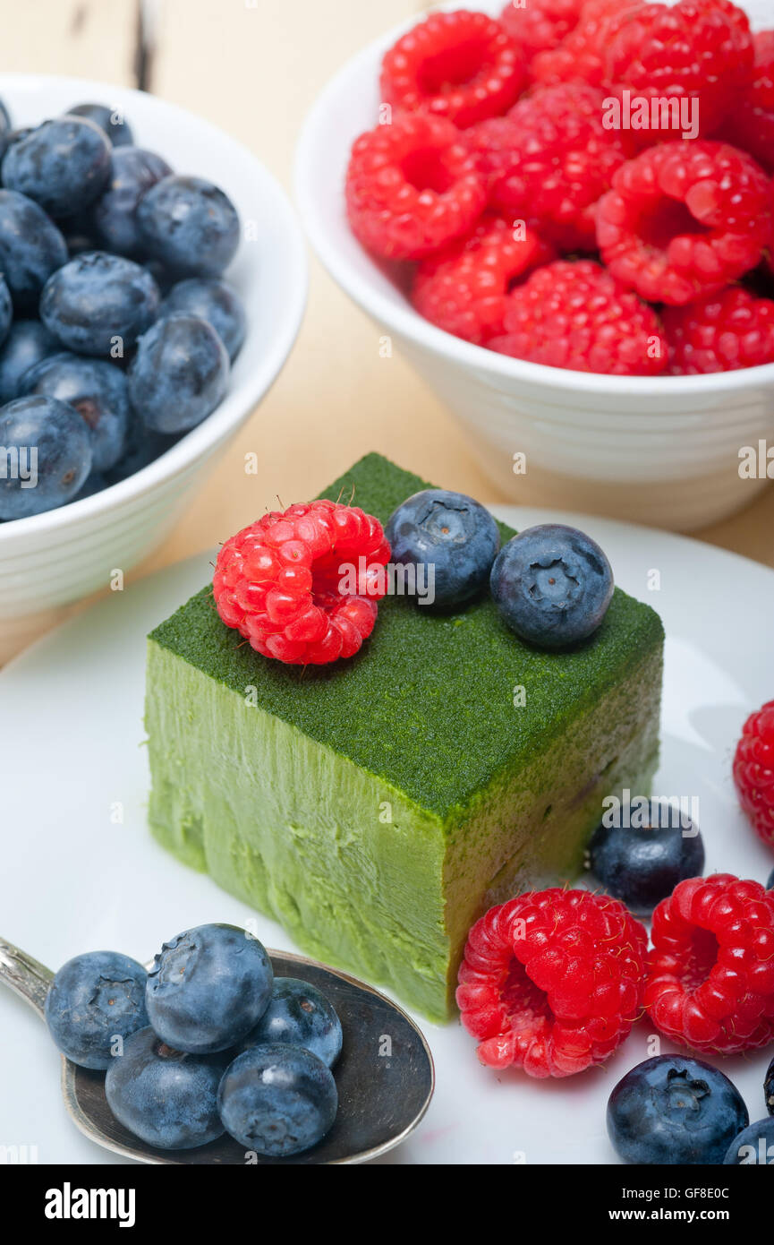 green tea matcha mousse cake with raspberries and blueberries on top ...
