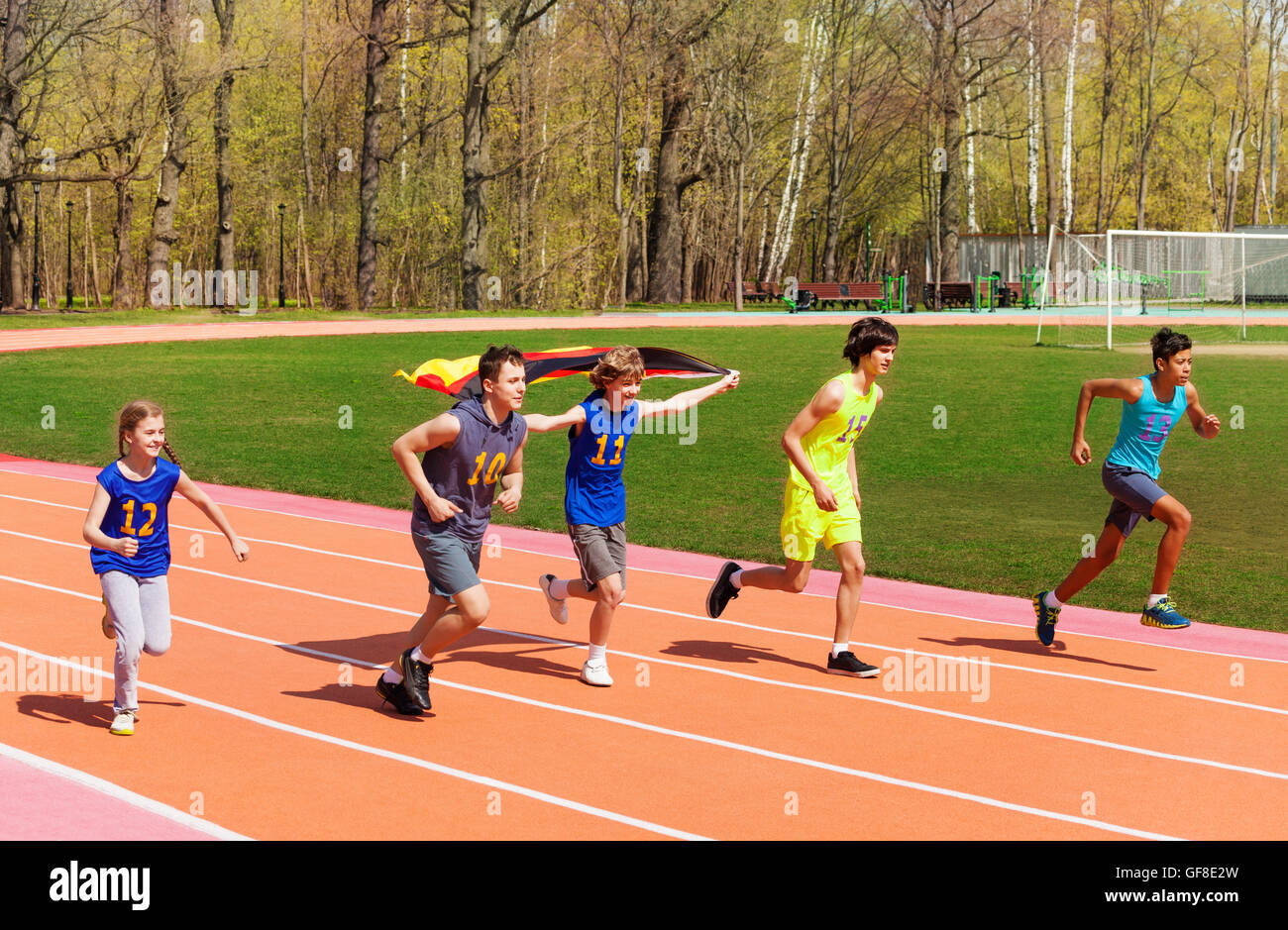 Five teenage sprinters running with German flag Stock Photo - Alamy