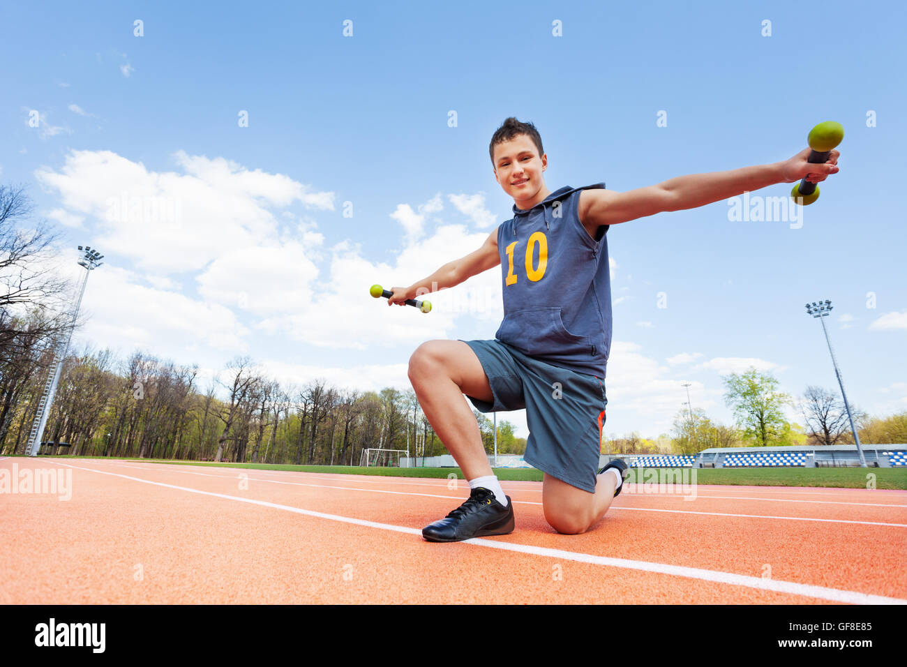 Active teenage boy doing exercises with dumbbells Stock Photo - Alamy
