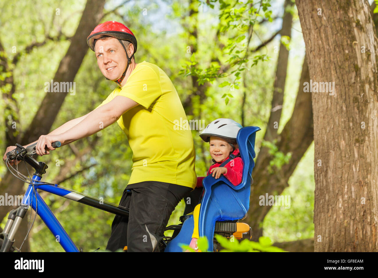 Happy father and his little daughter riding a bike Stock Photo - Alamy