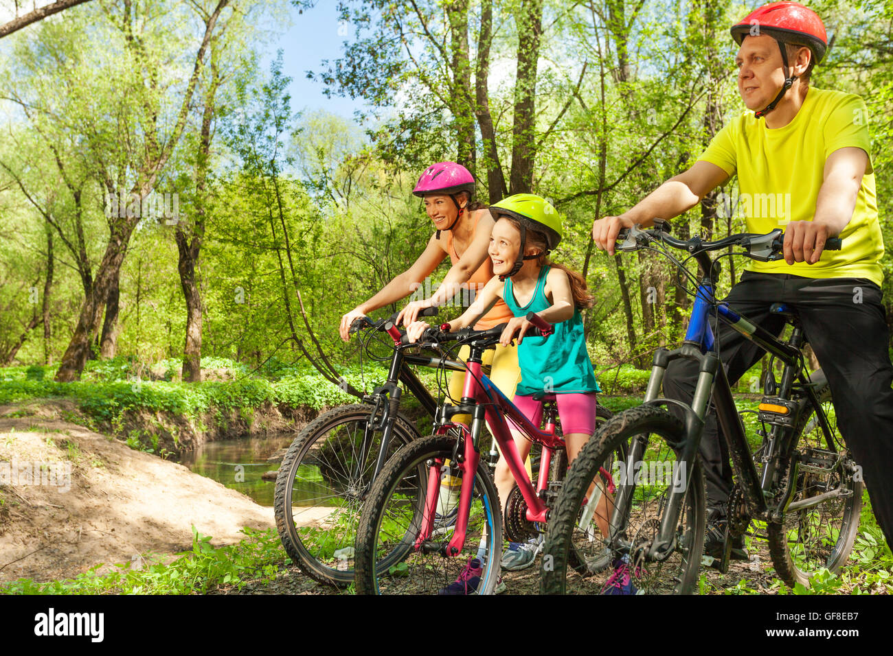 Happy cyclists admiring landscape of spring park Stock Photo - Alamy