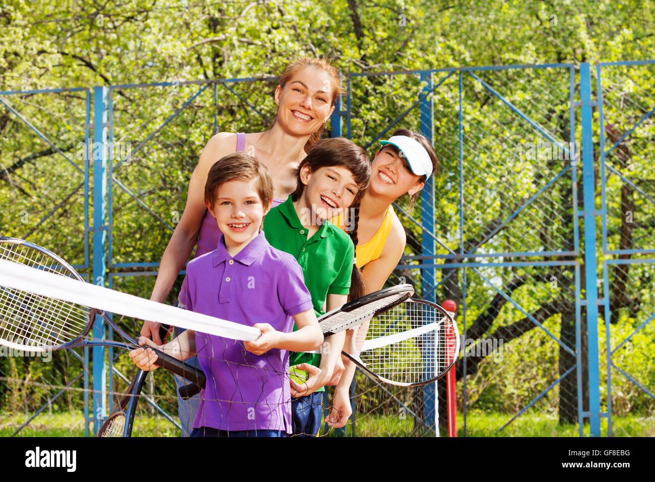 Active family having fun playing tennis Stock Photo - Alamy