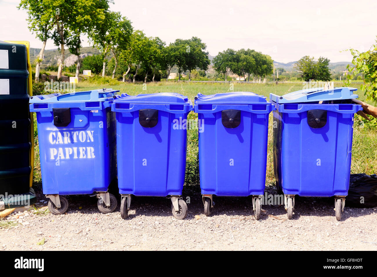Recycling bins for paper and cardboard on the side of the road in the ...