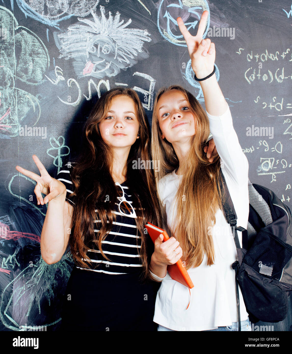 back to school after summer vacations, two teen real girls in classroom ...