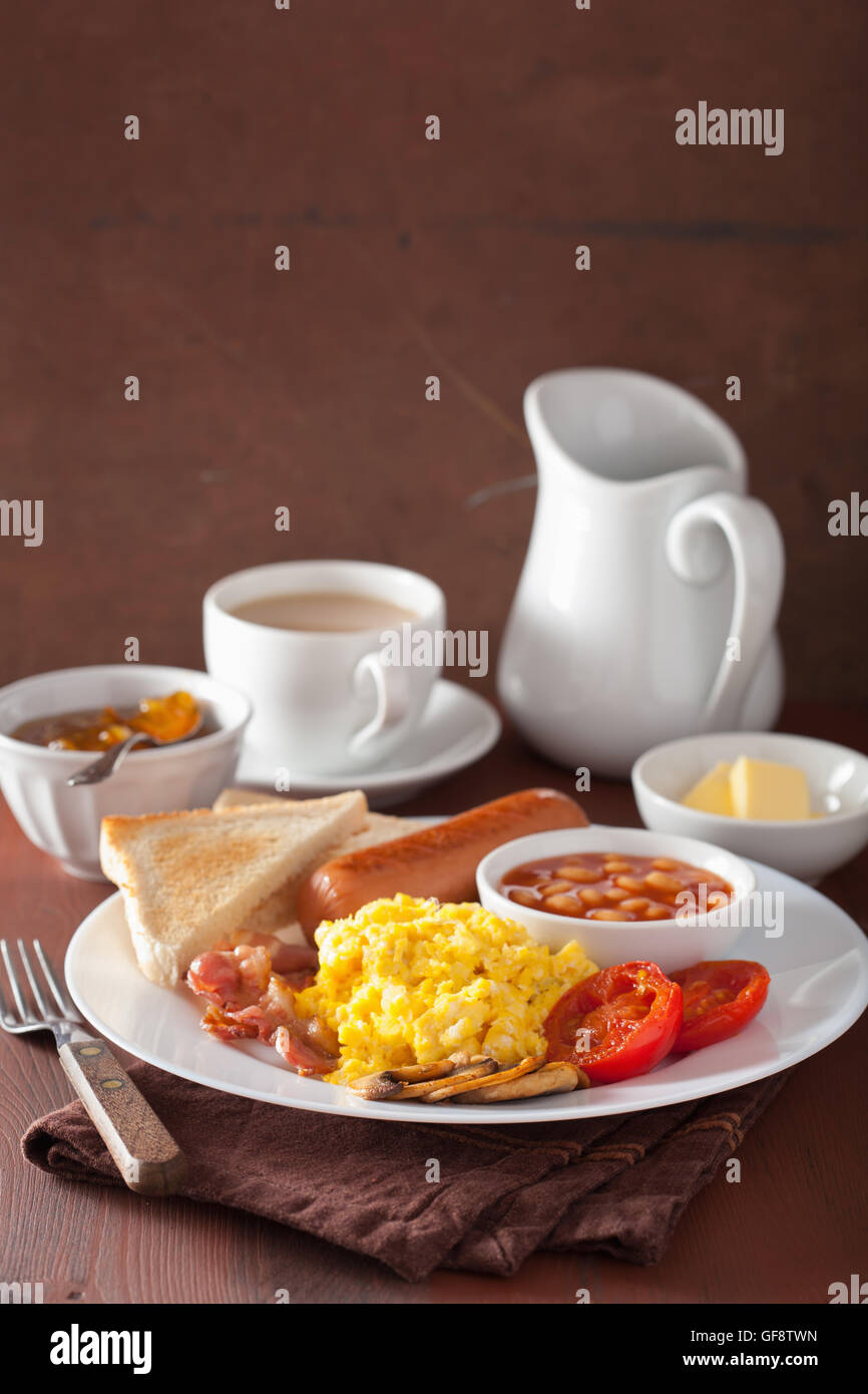 full english breakfast with scrambled eggs, bacon, sausage, beans ...