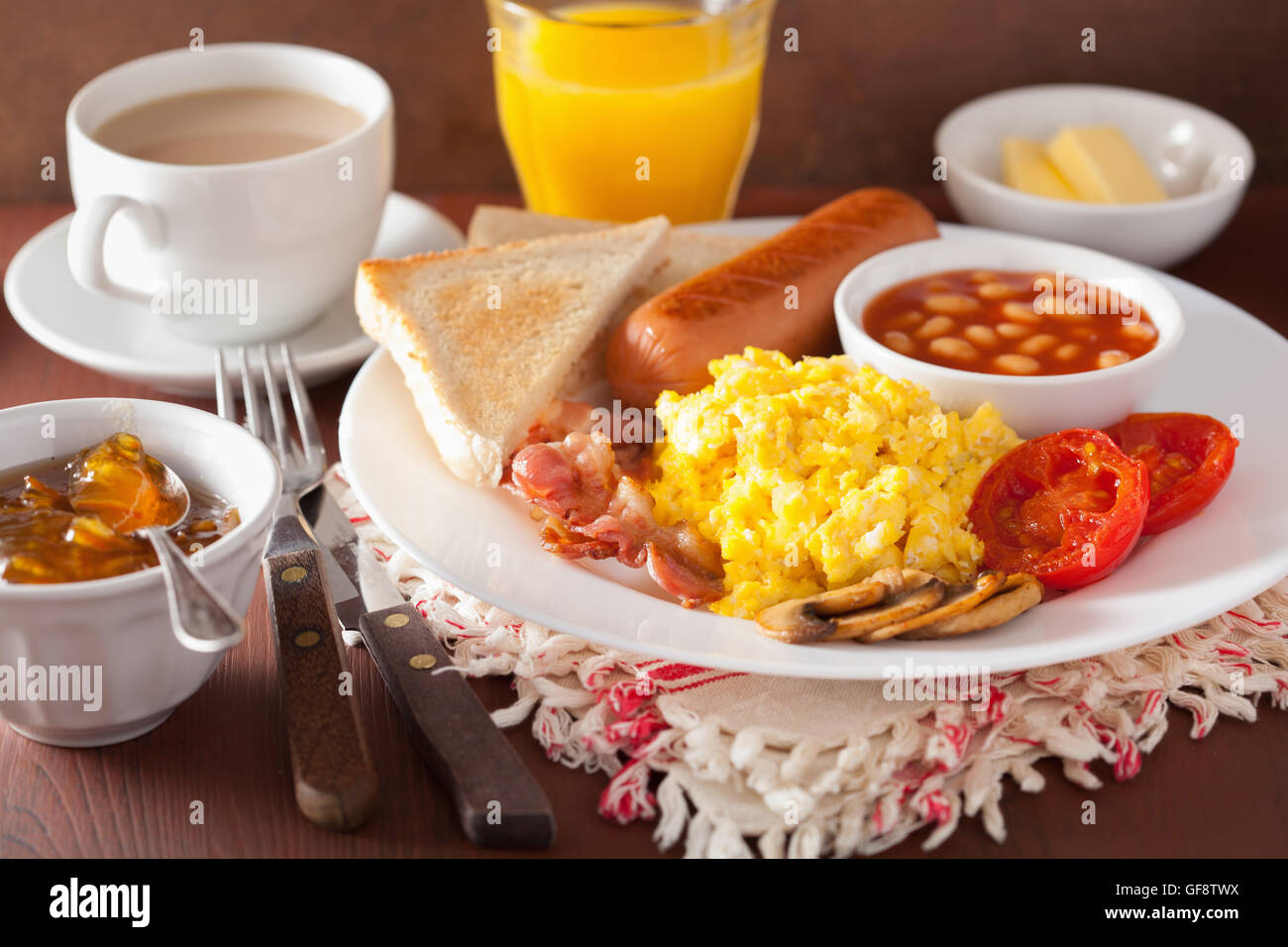 full english breakfast with scrambled eggs, bacon, sausage, beans ...