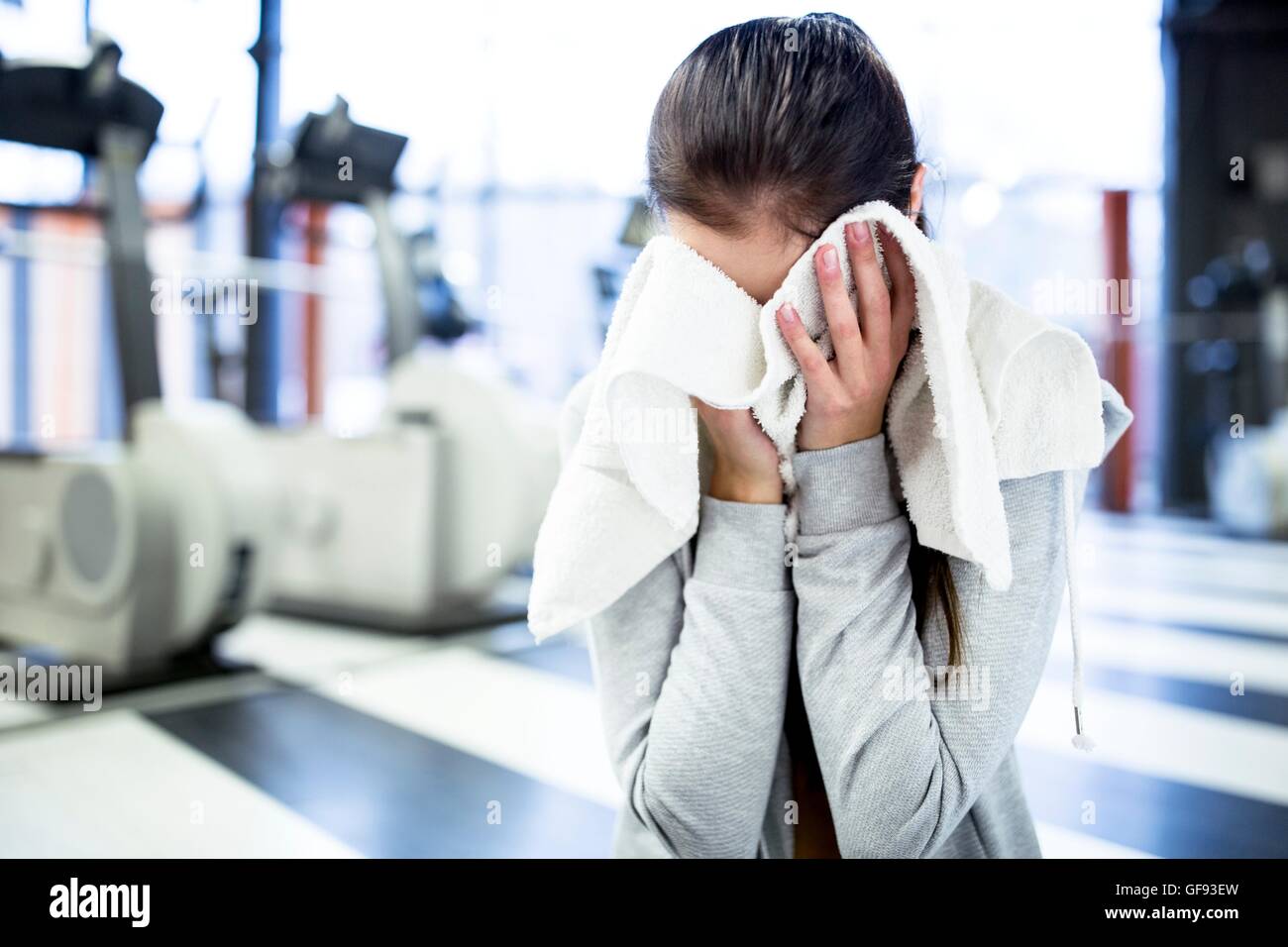 PROPERTY RELEASED. MODEL RELEASED. Cute young woman wiping her sweat ...