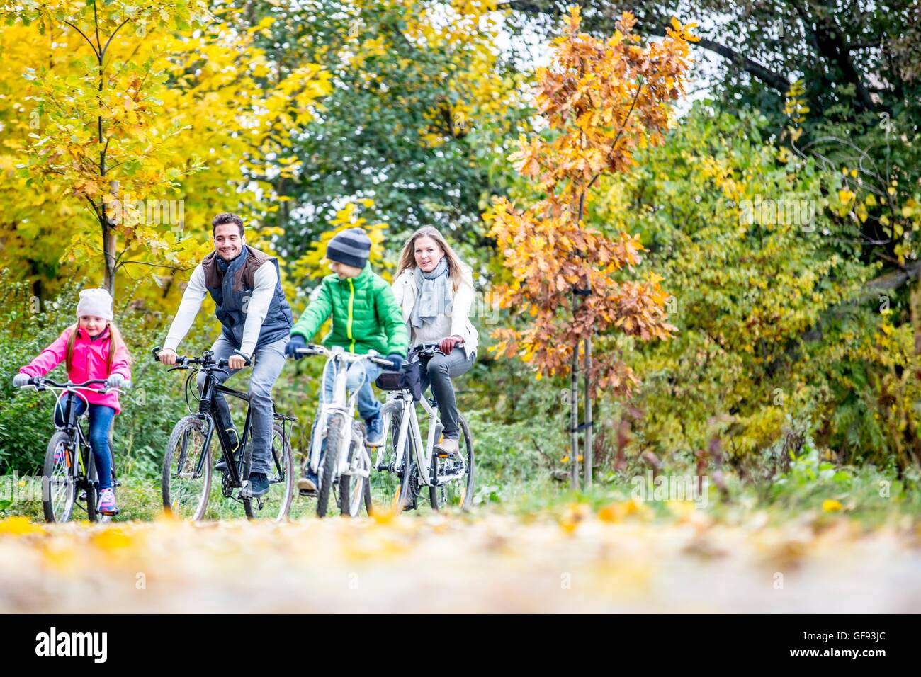 MODEL RELEASED. Family cycling together in autumn Stock Photo - Alamy