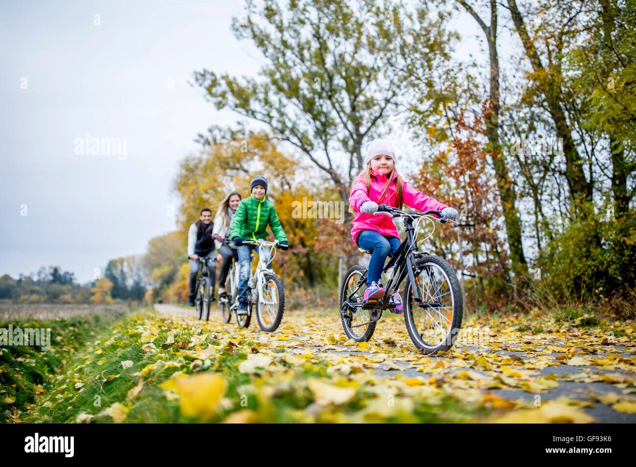 MODEL RELEASED. Family cycling together in autumn Stock Photo - Alamy
