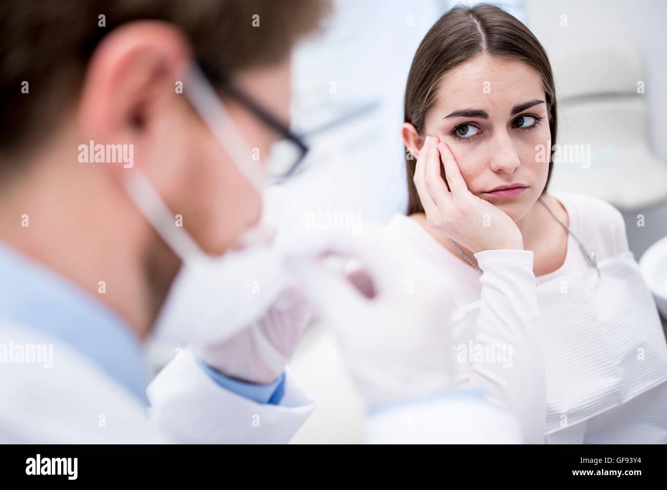 MODEL RELEASED. Sad patient looking at dentist in dentist clinic Stock ...