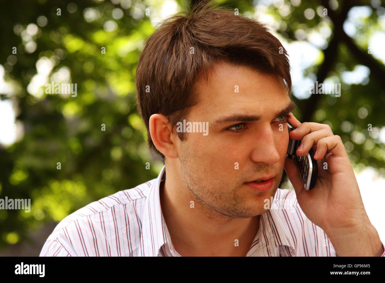 Portrait of young attractive man calling by phone Stock Photo - Alamy