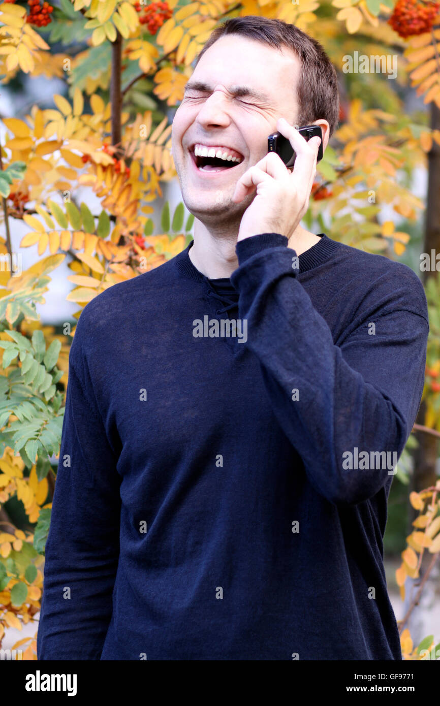 Portrait of young attractive man calling by phone Stock Photo - Alamy