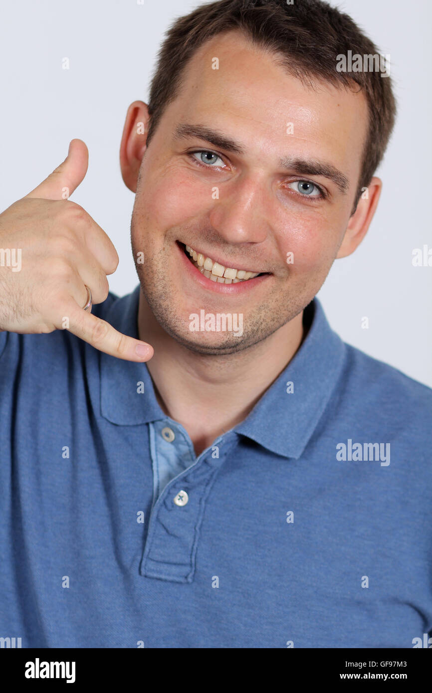 Closeup handsome young man making call me gesture Stock Photo - Alamy