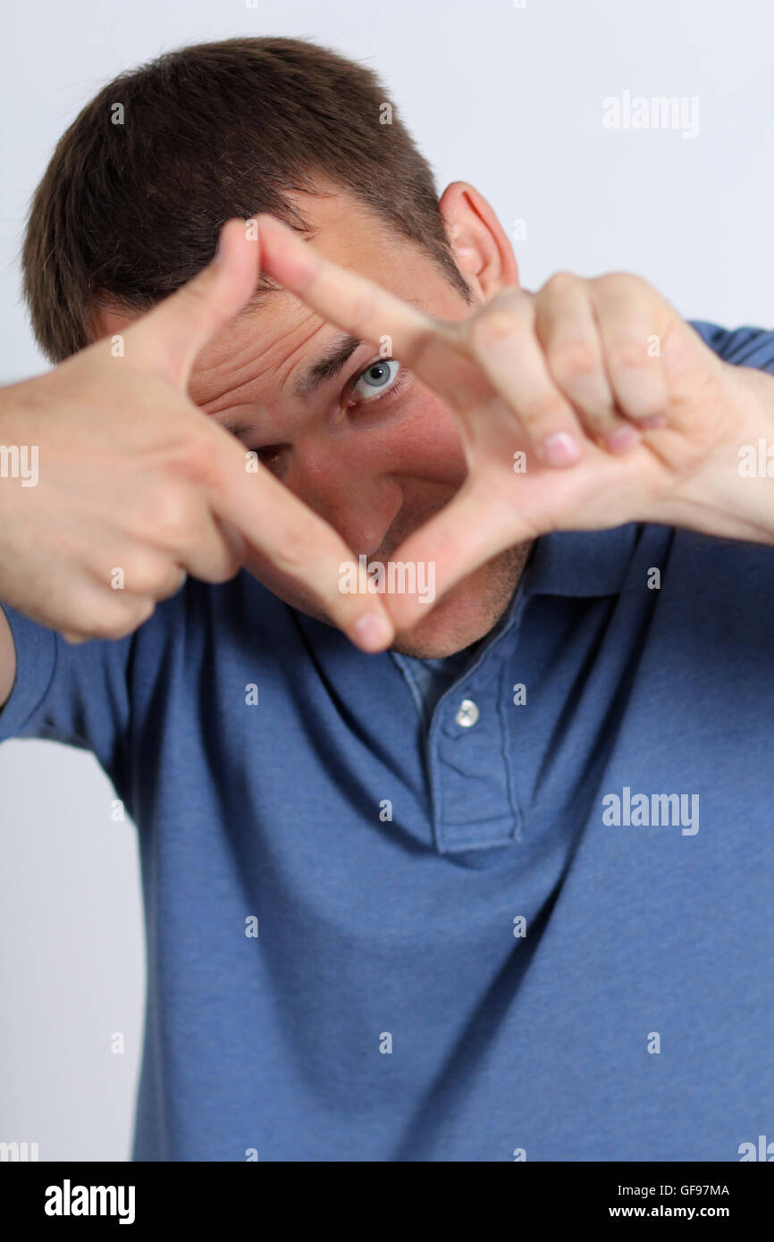Attractive man making a frame around his face Stock Photo - Alamy