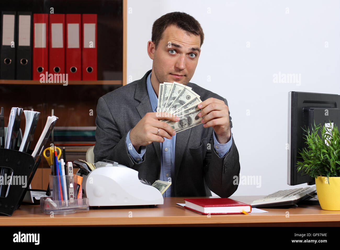 A young man with dollars in their hands Stock Photo - Alamy