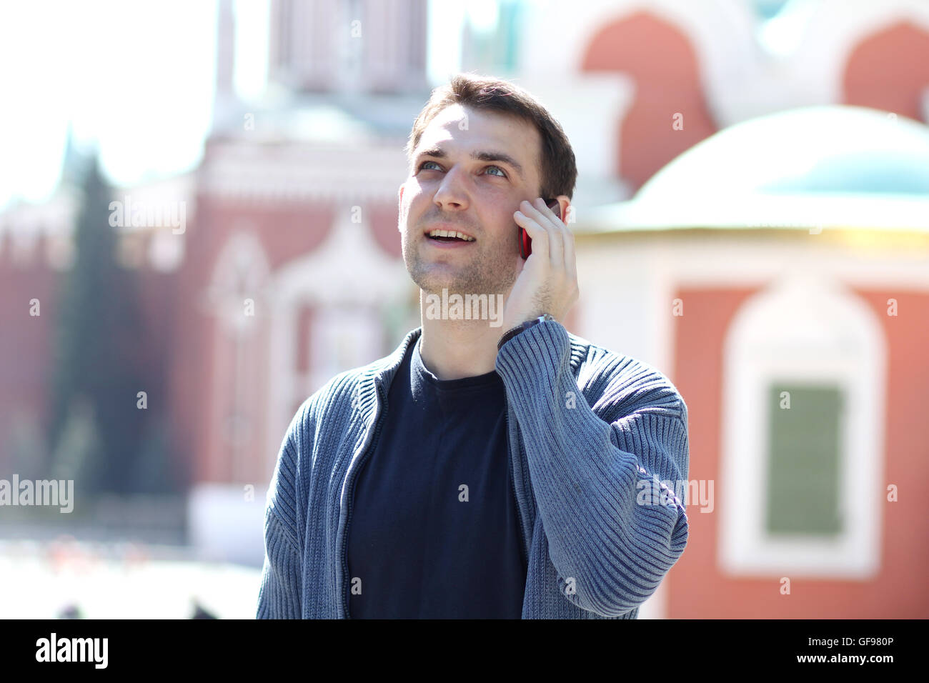 happy men calling by phone in summer street Stock Photo - Alamy