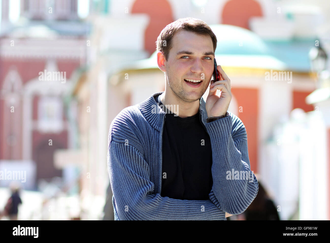 happy men calling by phone in summer street Stock Photo - Alamy