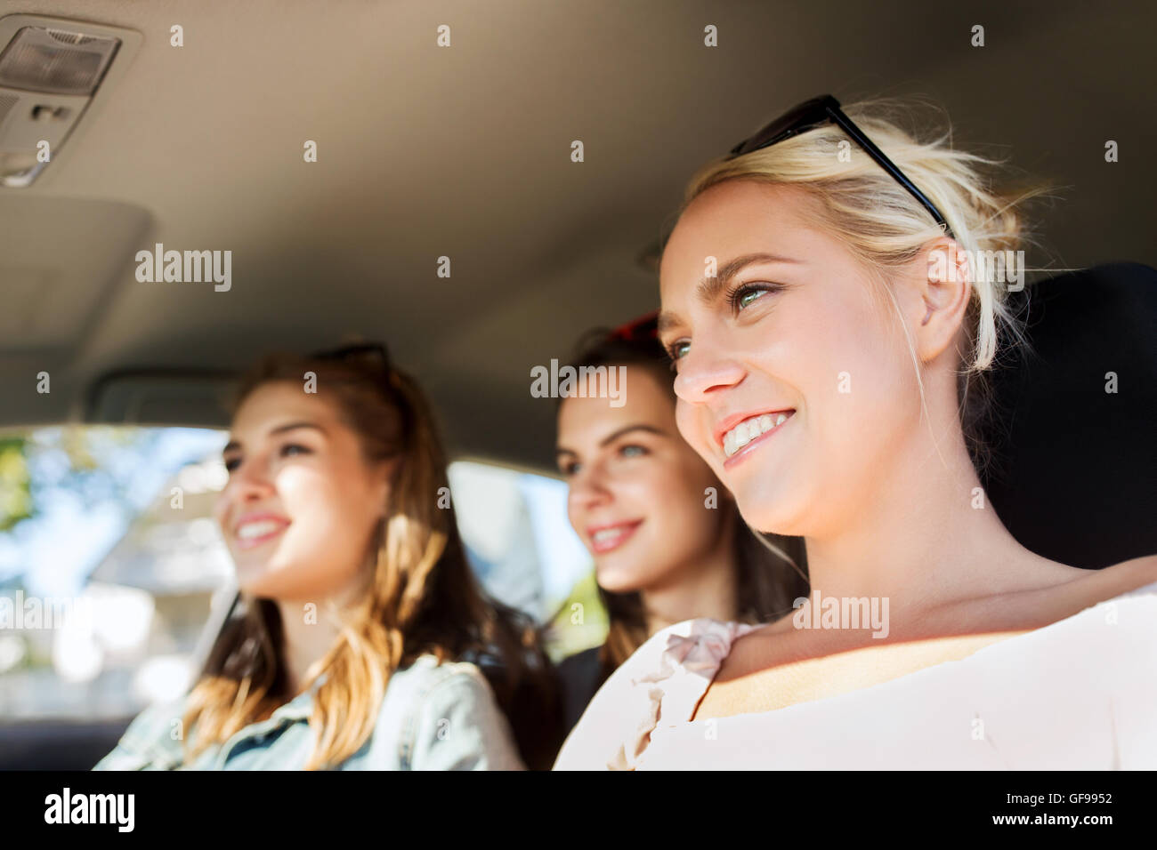 happy teenage girls or young women driving in car Stock Photo - Alamy