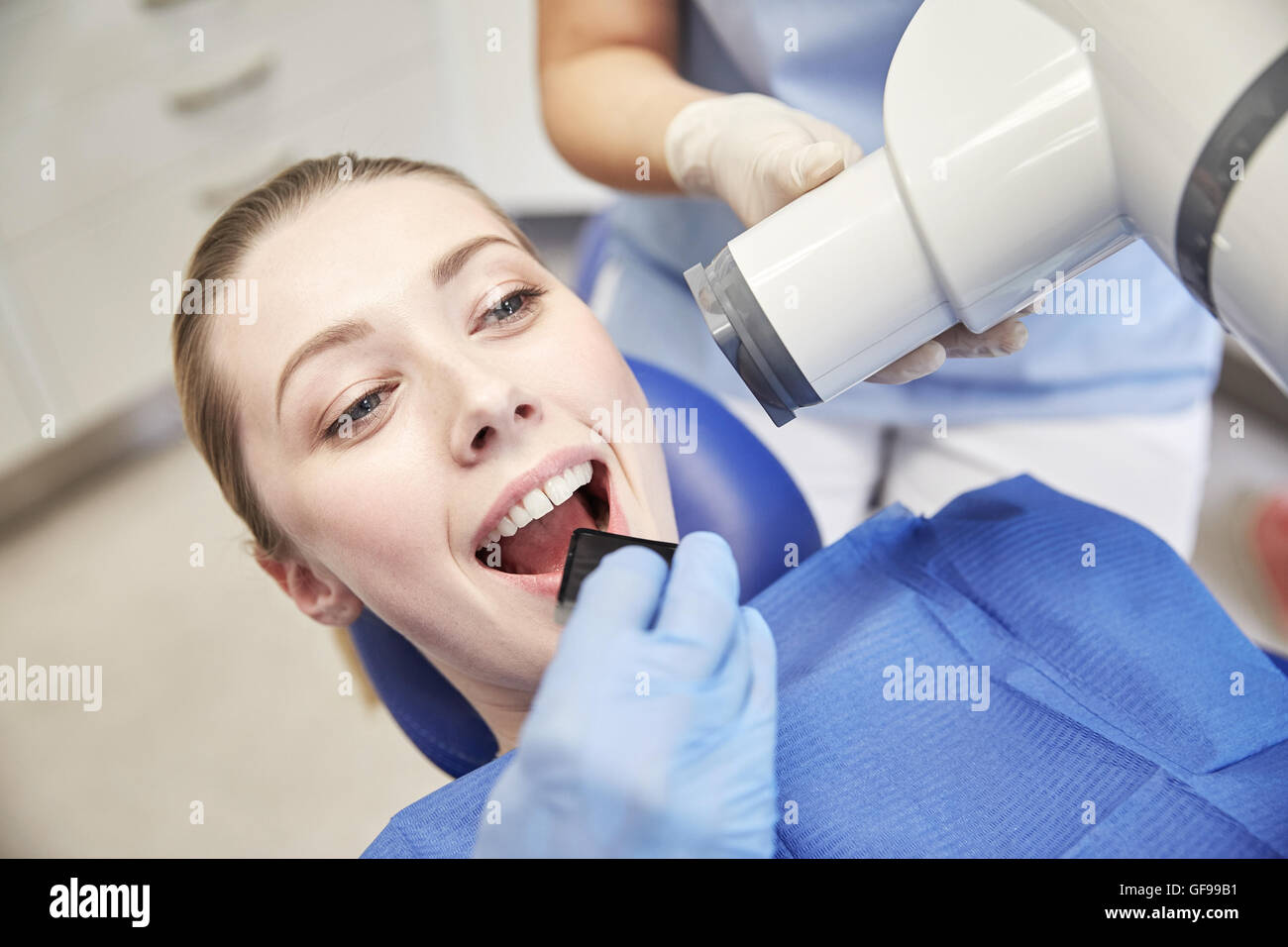 female patient face with x-ray machine and shield Stock Photo - Alamy