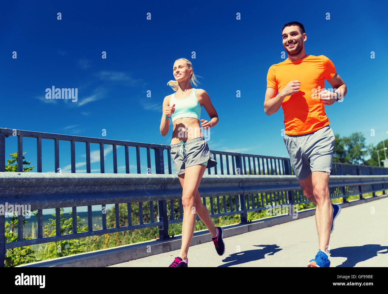 smiling couple running at summer seaside Stock Photo - Alamy
