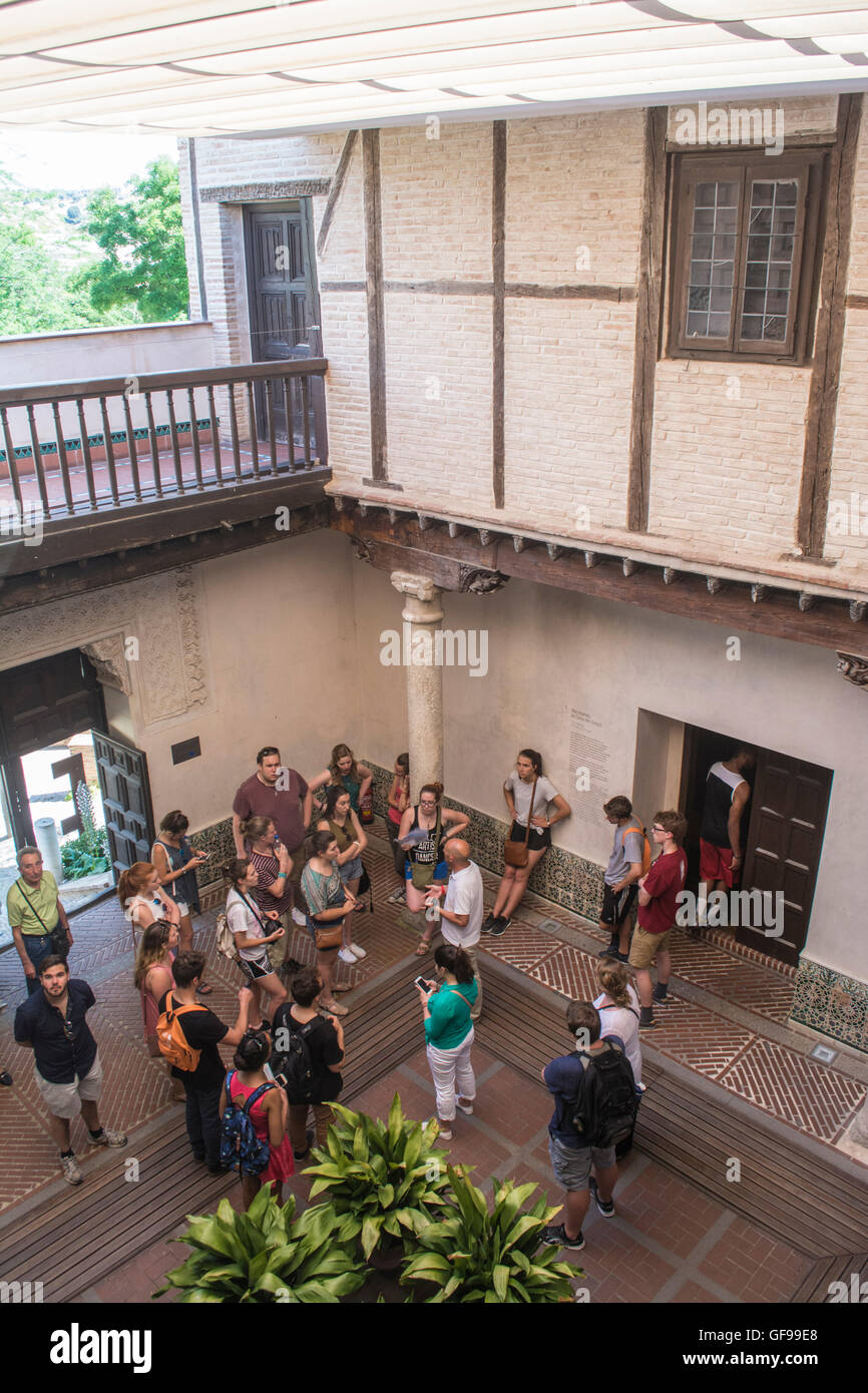 Party of tourists and tour guide in the courtyard of the El Greco ...