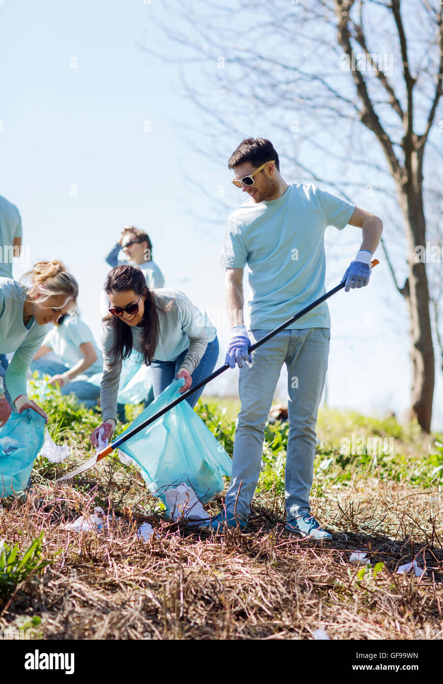 volunteers with garbage bags cleaning park area Stock Photo - Alamy
