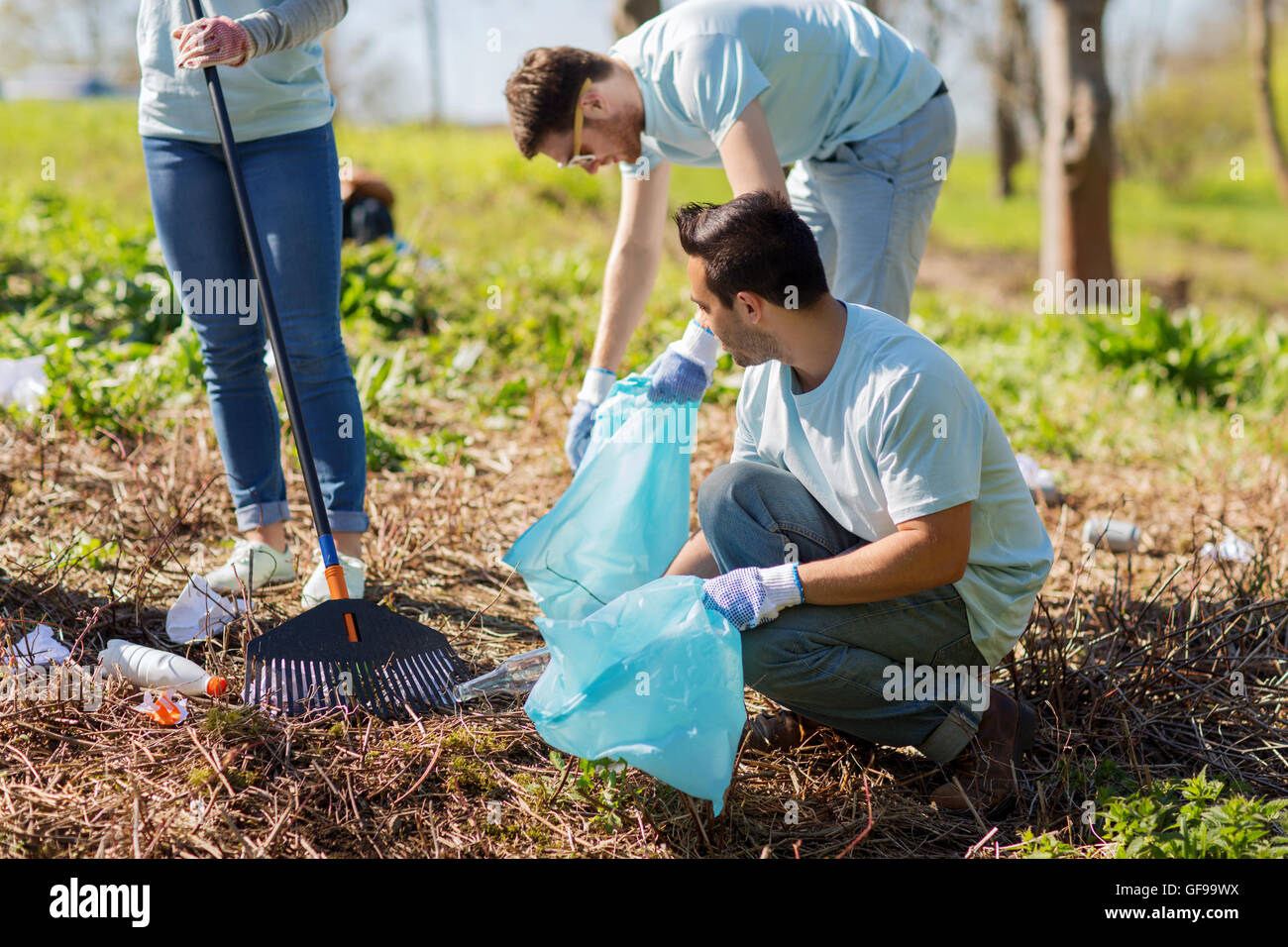 volunteers with garbage bags cleaning park area Stock Photo - Alamy