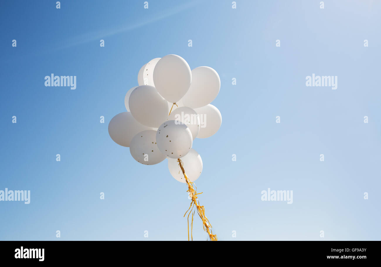 close up of white helium balloons in blue sky Stock Photo - Alamy