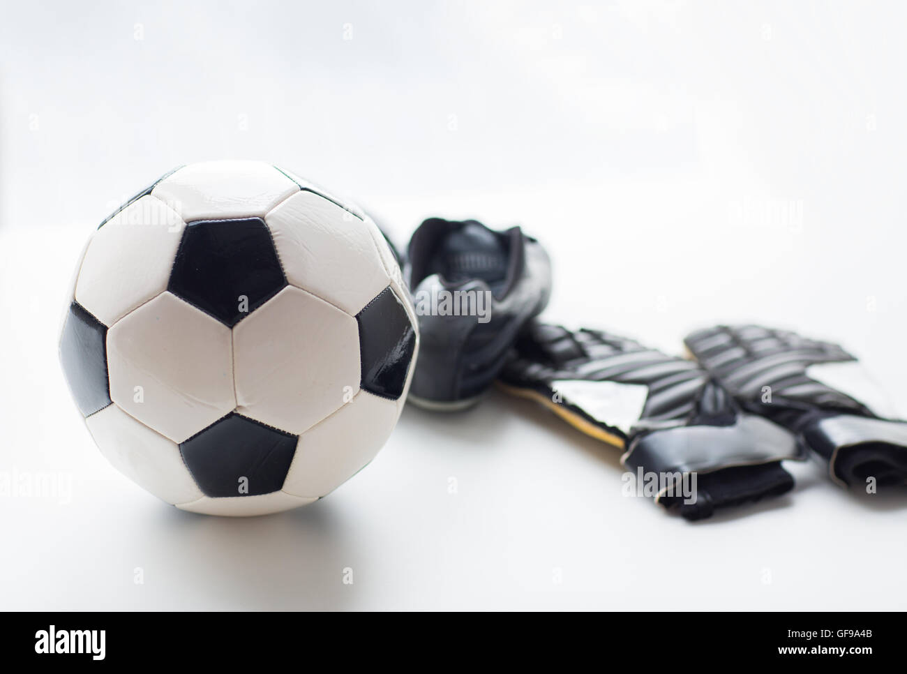 close up of soccer ball, boots and gloves on table Stock Photo - Alamy