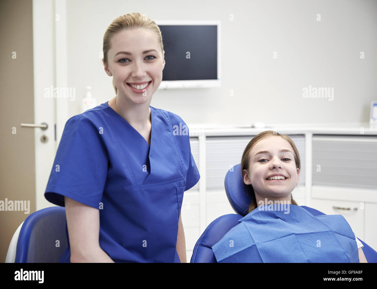happy female dentist with patient girl at clinic Stock Photo - Alamy