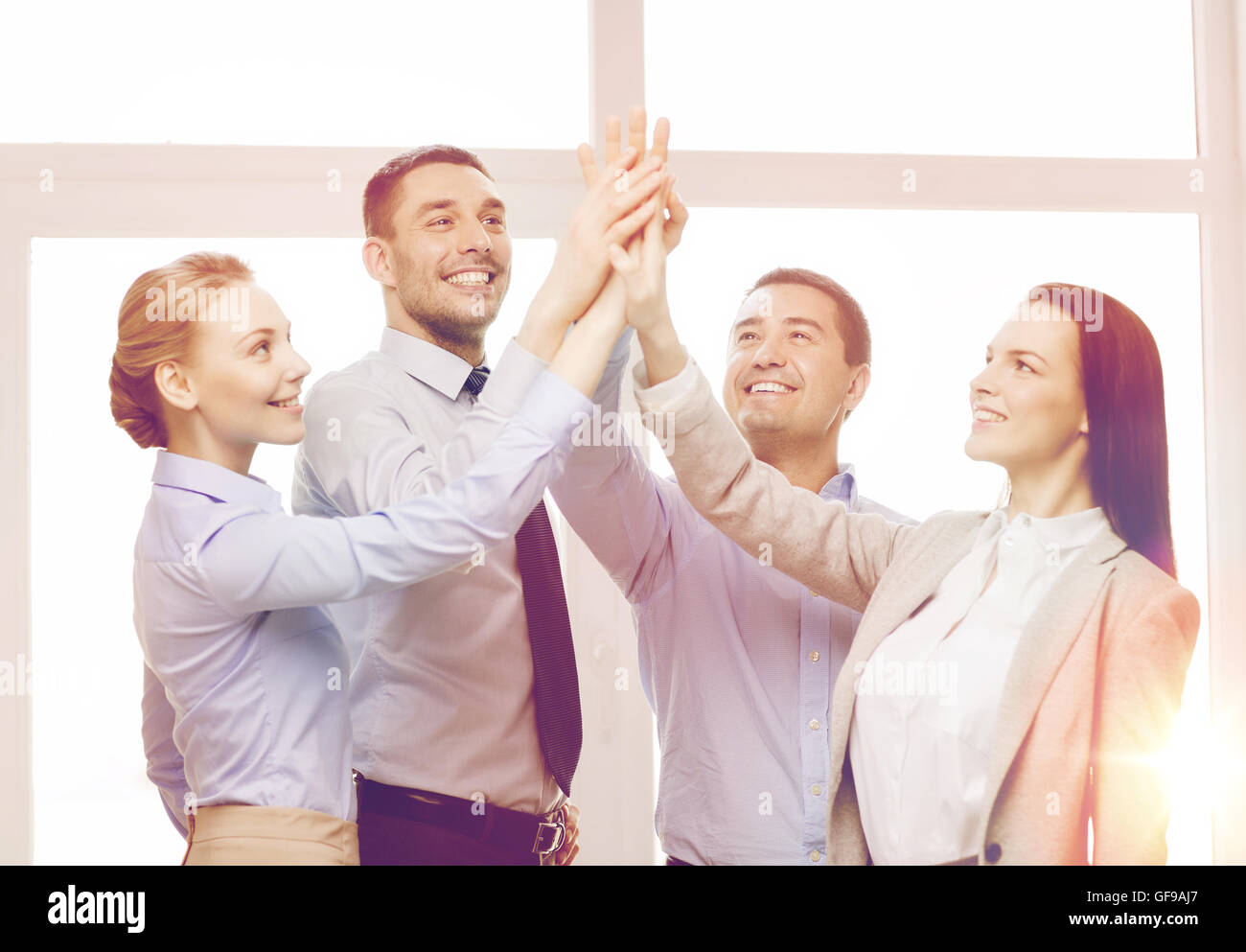 happy business team giving high five in office Stock Photo - Alamy