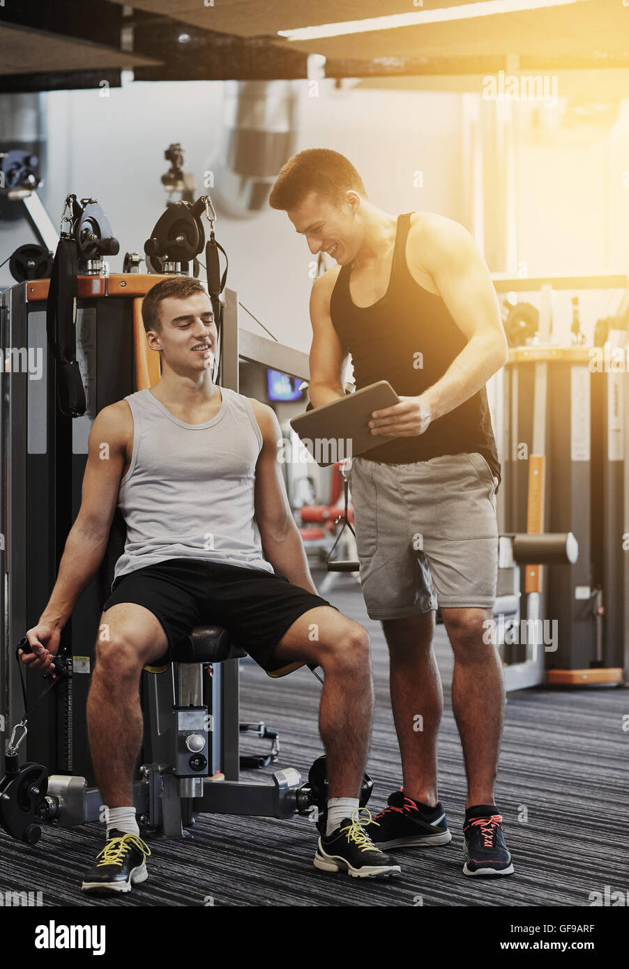 men exercising on gym machine Stock Photo - Alamy
